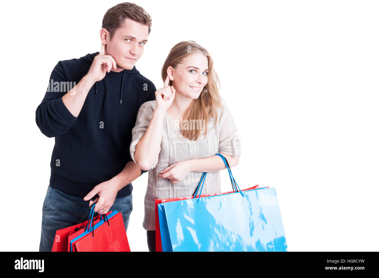 Couple holding shopping bags making can't hear gesture isolated on ...