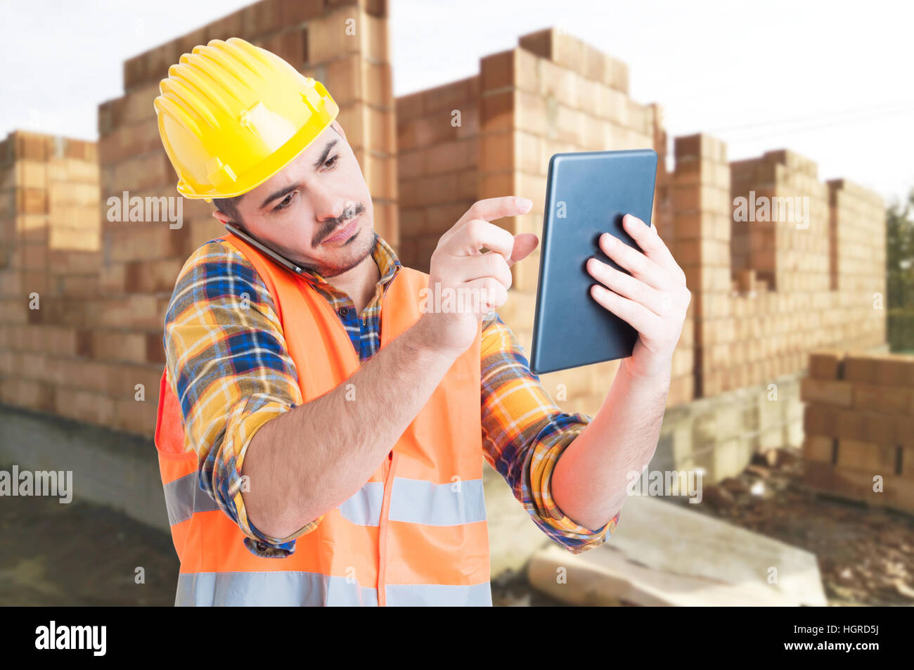Construction specialist using tablet hi-res stock photography and ...