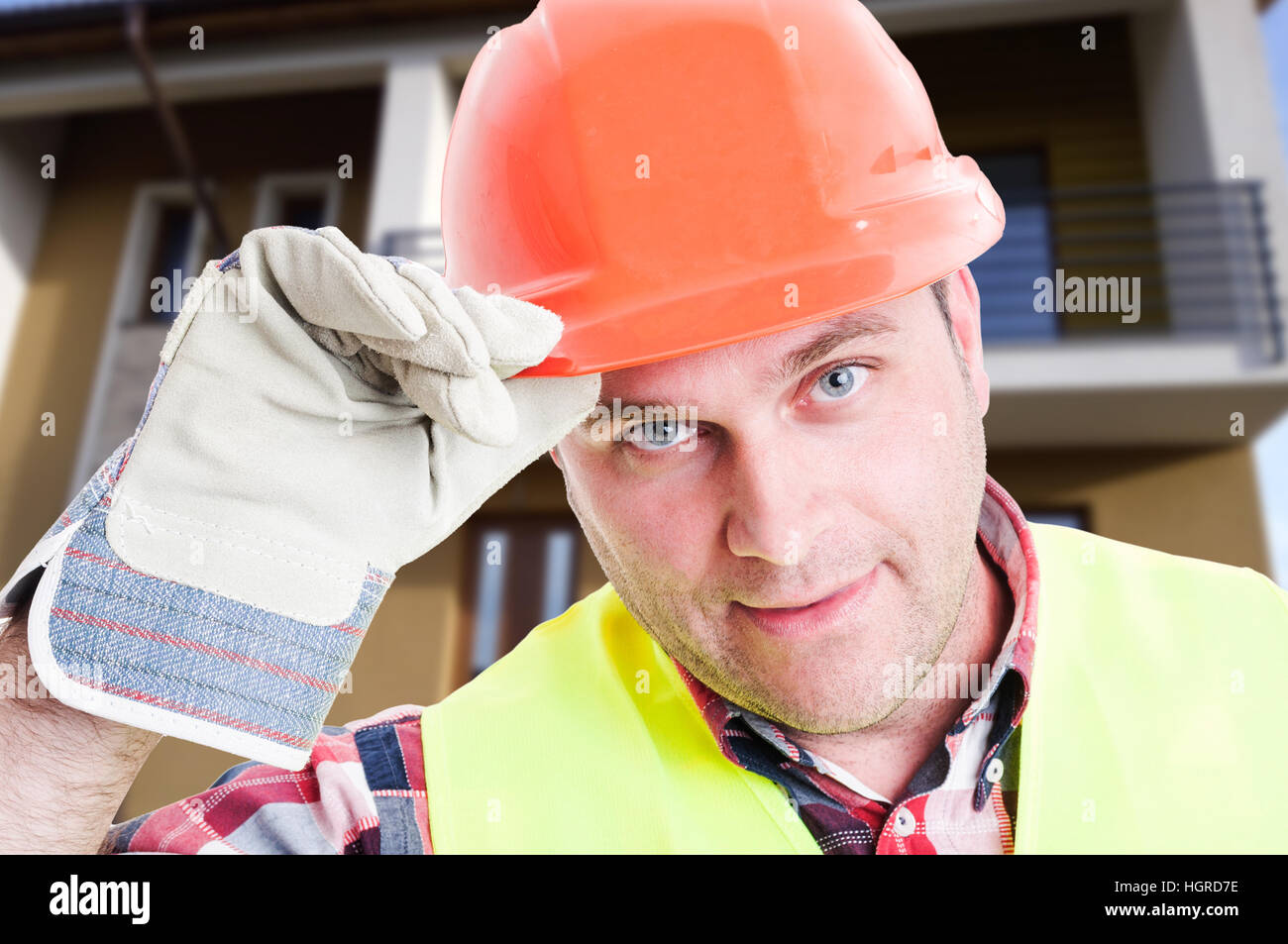 Closeup of handsome constructor or employee making a polite gesture as ...