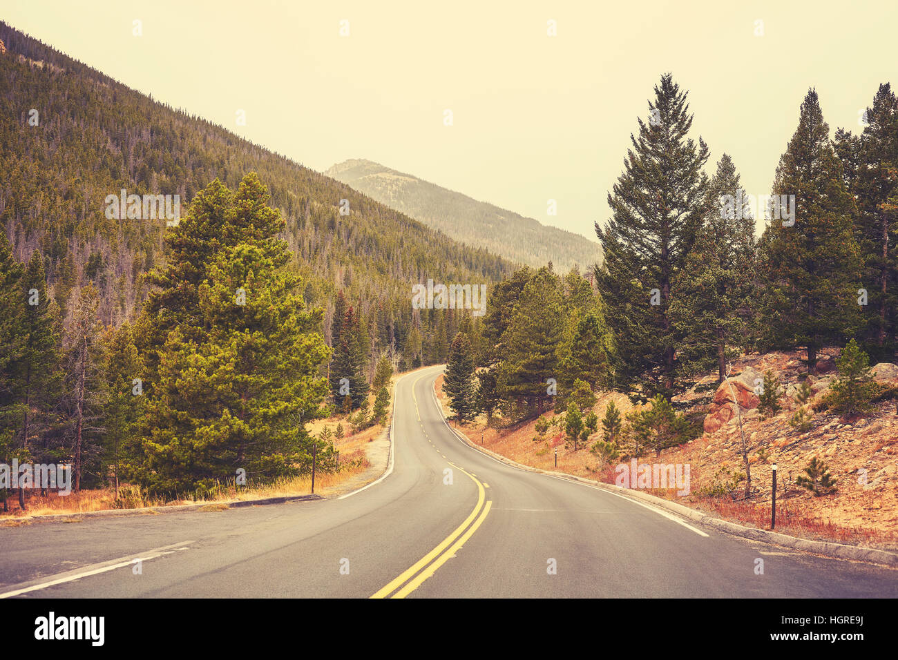 Retro color toned empty road in Rocky Mountains National Park on a ...