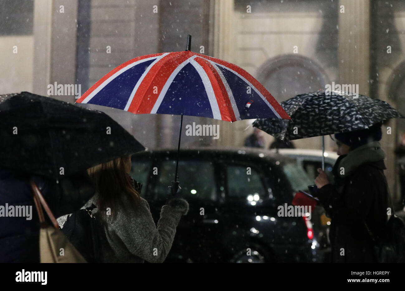 People during a snow flurry at Bank, City of London, as blizzard ...