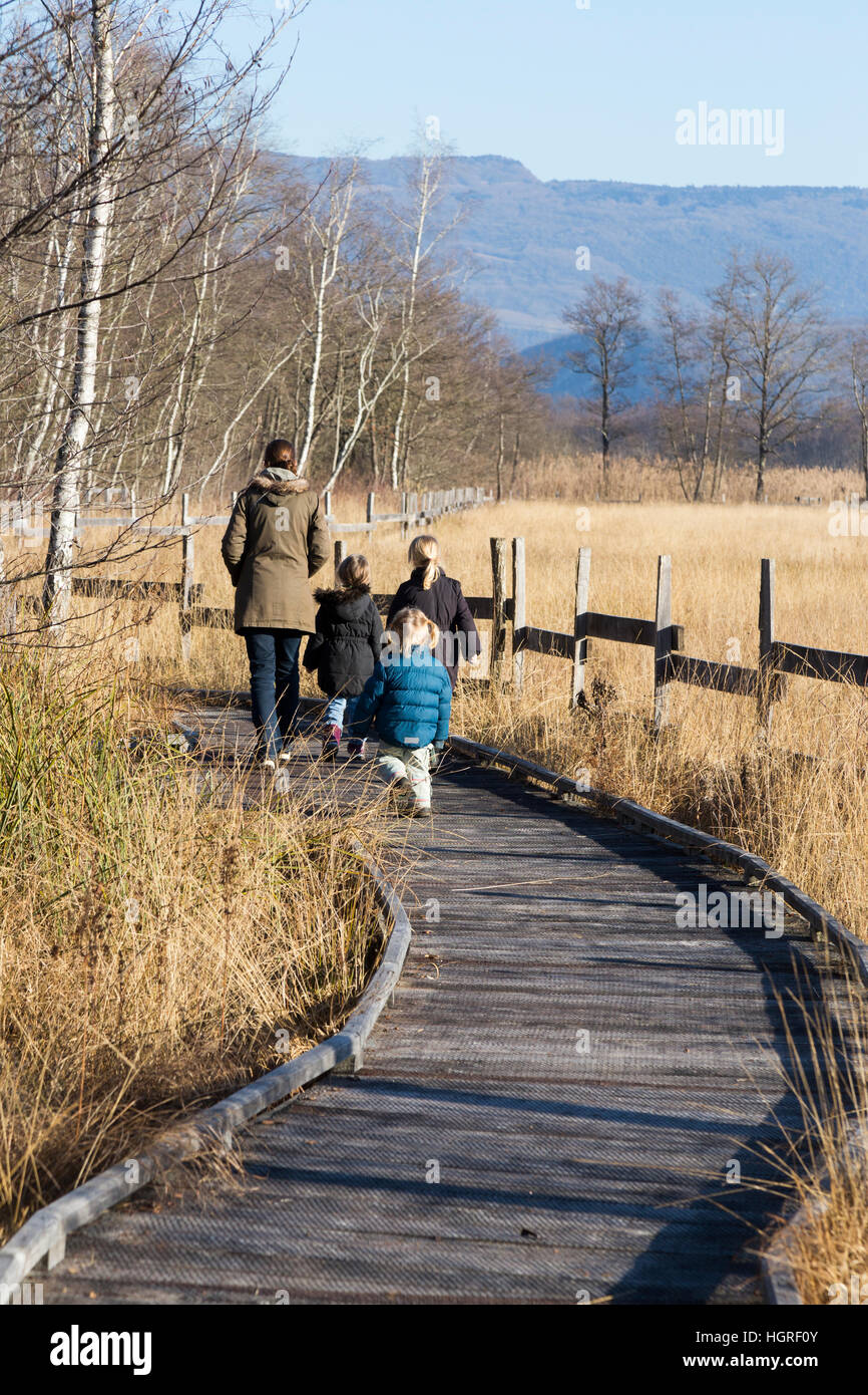 Mother & 3 children three kids daughters on walkway pathway foot path ...