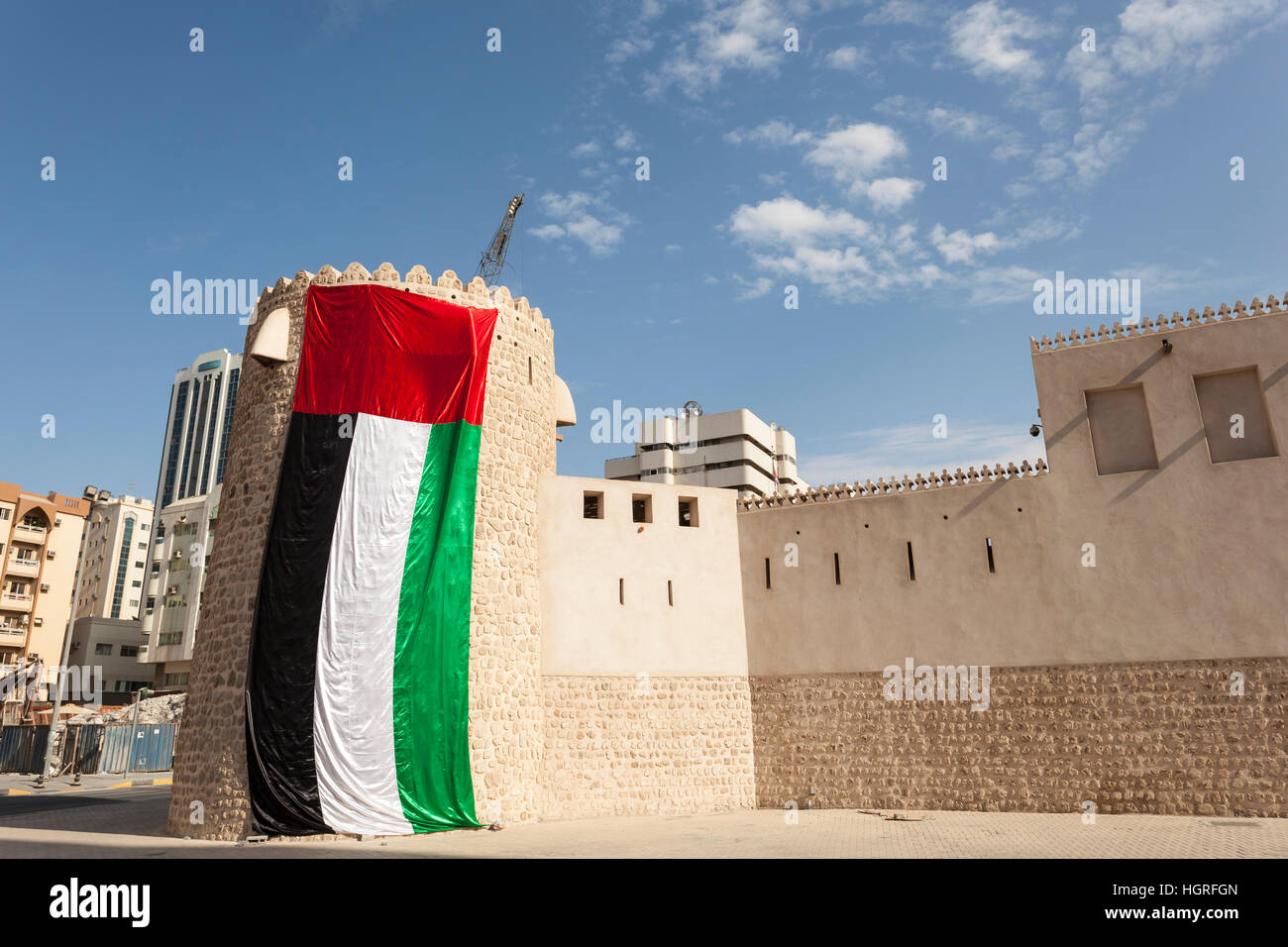 Historic fort decorated with UAE national flag Stock Photo - Alamy