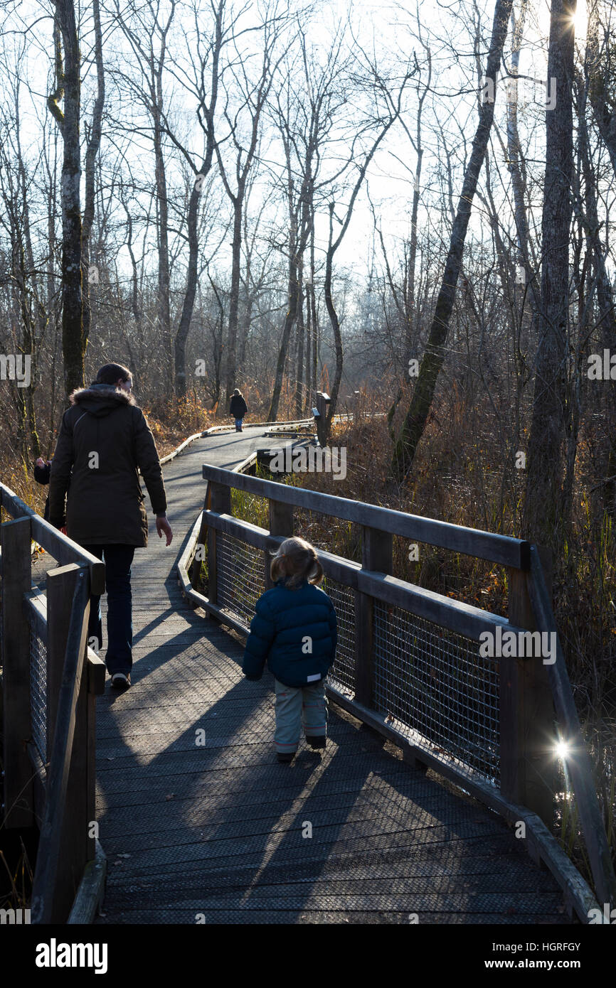Mother & 3 children three kids daughters on walkway pathway foot path ...