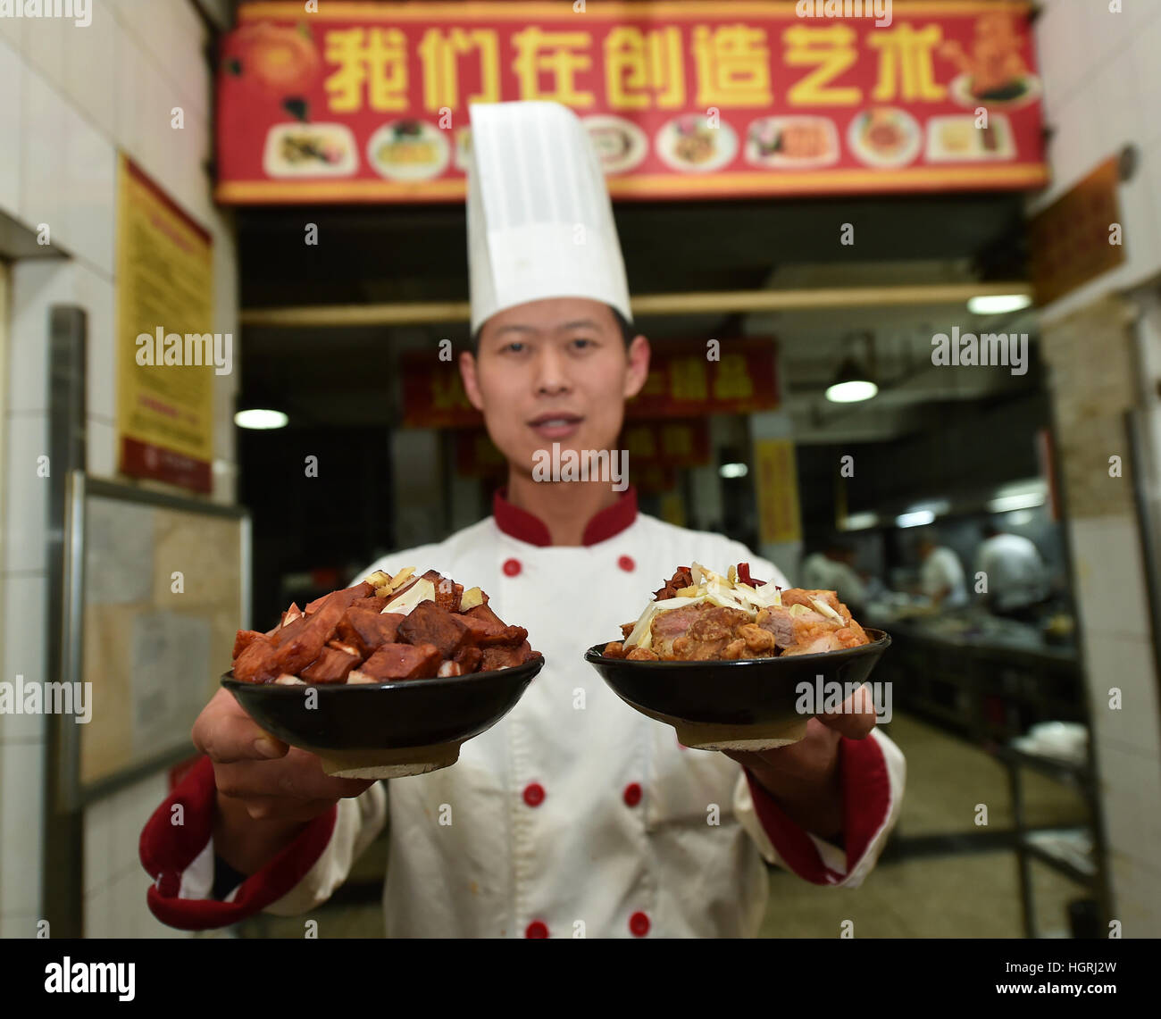 Fenyang, China. 11th Jan, 2017. Chef Sun Jinyong shows two dishes of ...