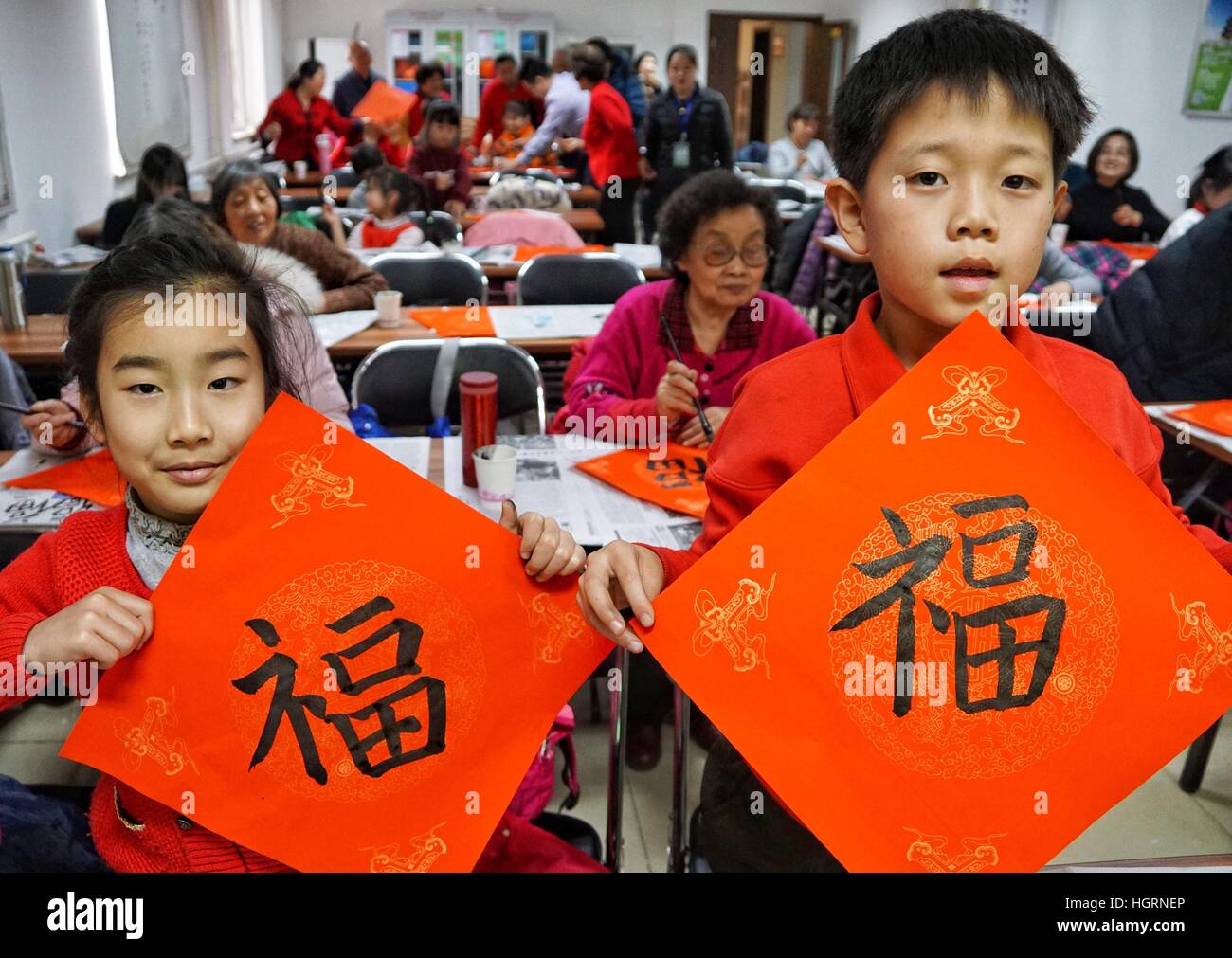 Beijing, China. 12th Jan, 2017. Children show their handwritten Chinese ...