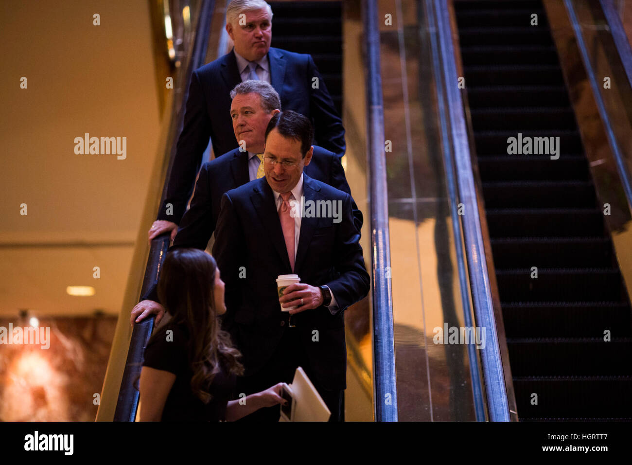 Randall Stephenson, the CEO of AT&T (in front with pink tie) arrives at ...
