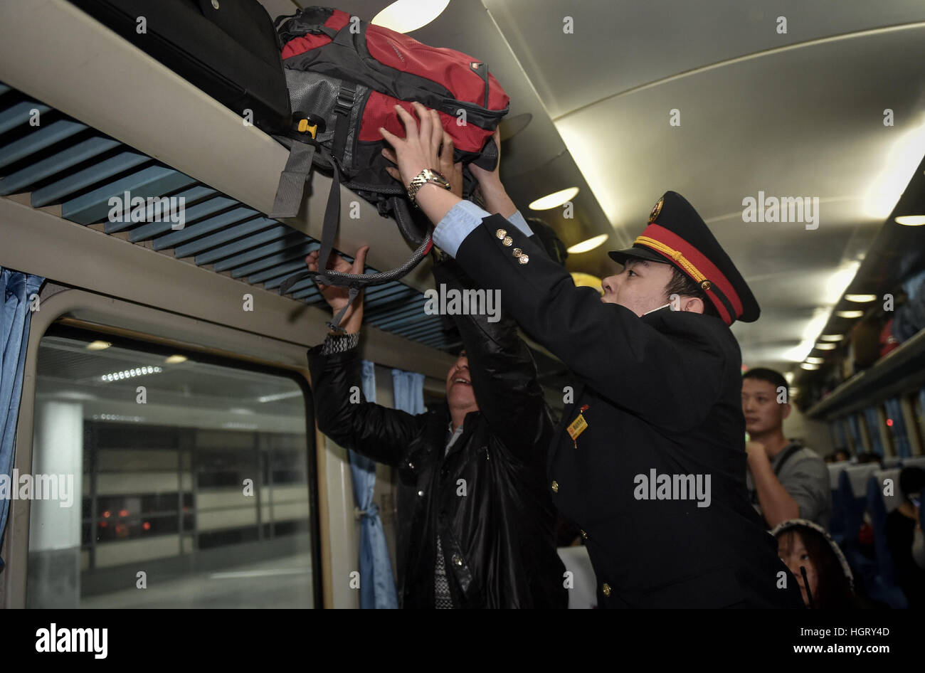 Shenzhen, China's Guangdong Province. 13th Jan, 2017. A steward helps a ...