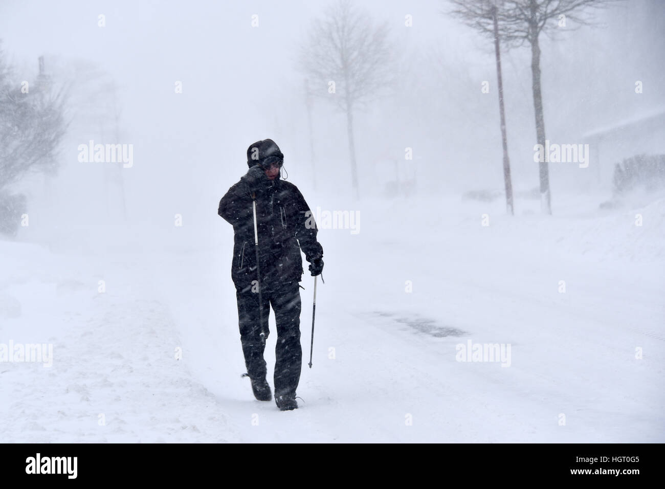 Usseln, Germany. 13th Jan, 2017. A man walks along a street rather than ...