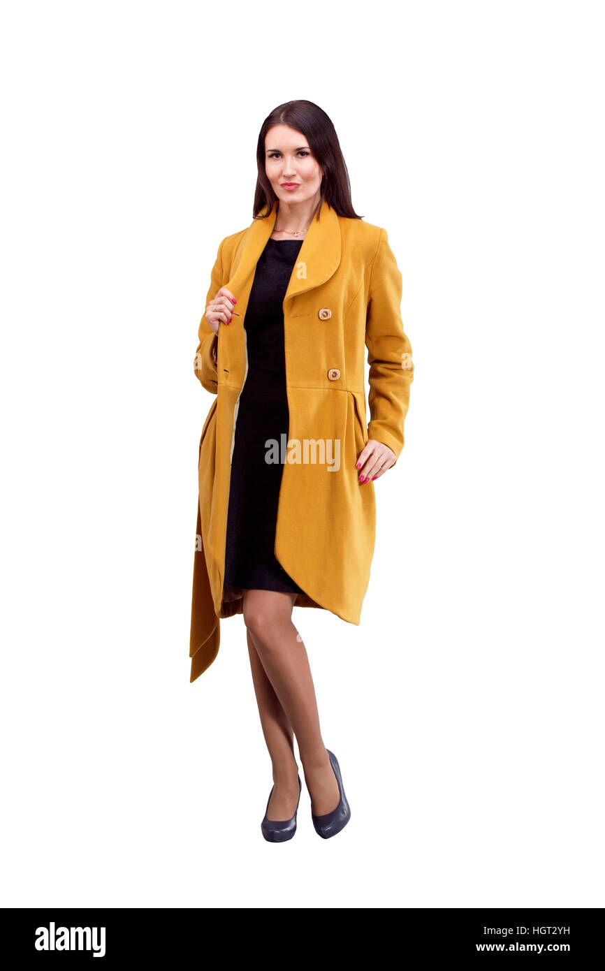 Portrait of fashion girl in yellow coat posing on light background ...