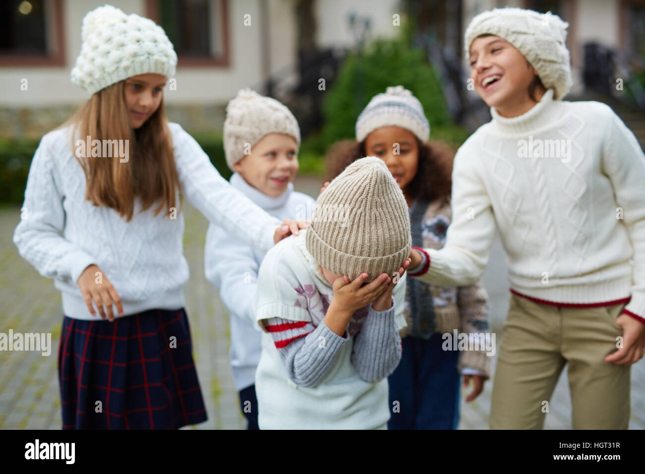 Classmates laughing at unhappy boy Stock Photo - Alamy