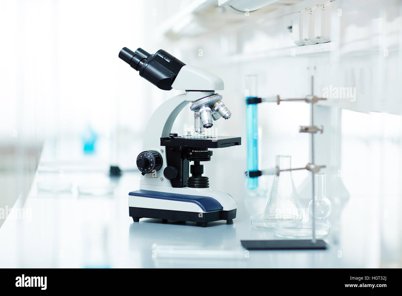 Empty glassware and microscope in chemical laboratory Stock Photo - Alamy