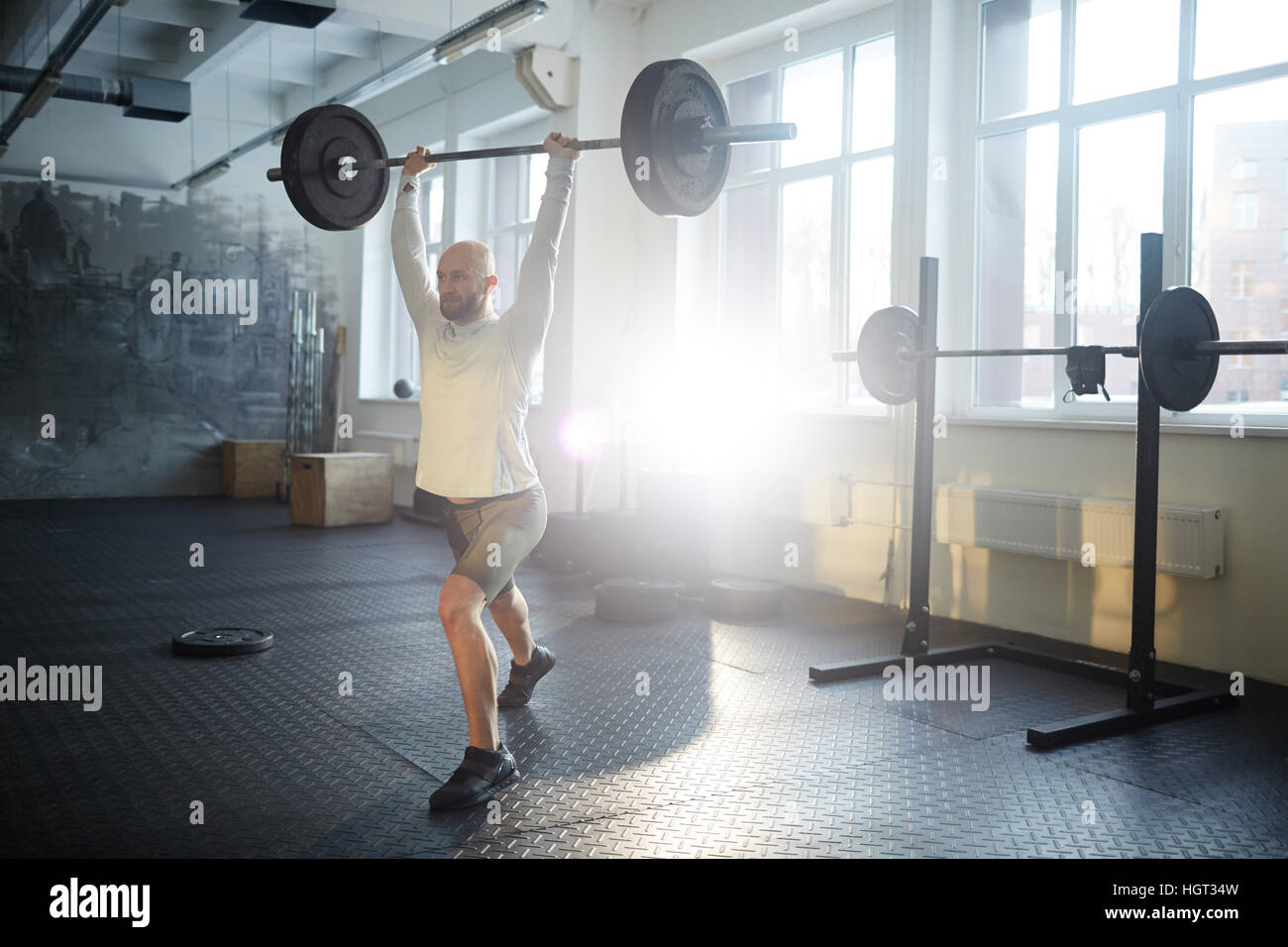 Sportsman keeping balance while lifting weight Stock Photo - Alamy