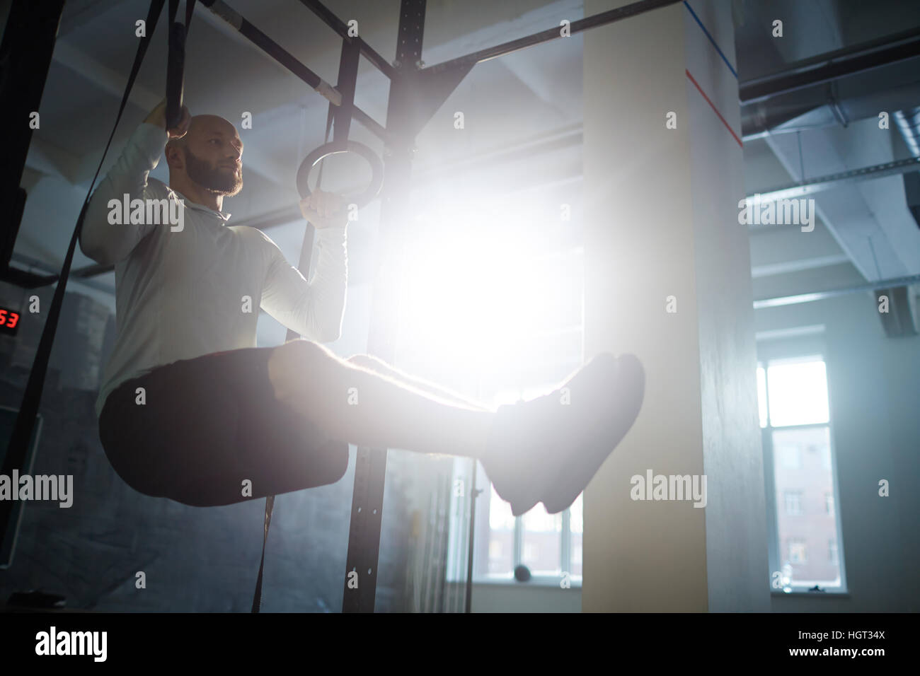 Man pulling up on special sport equipment Stock Photo - Alamy