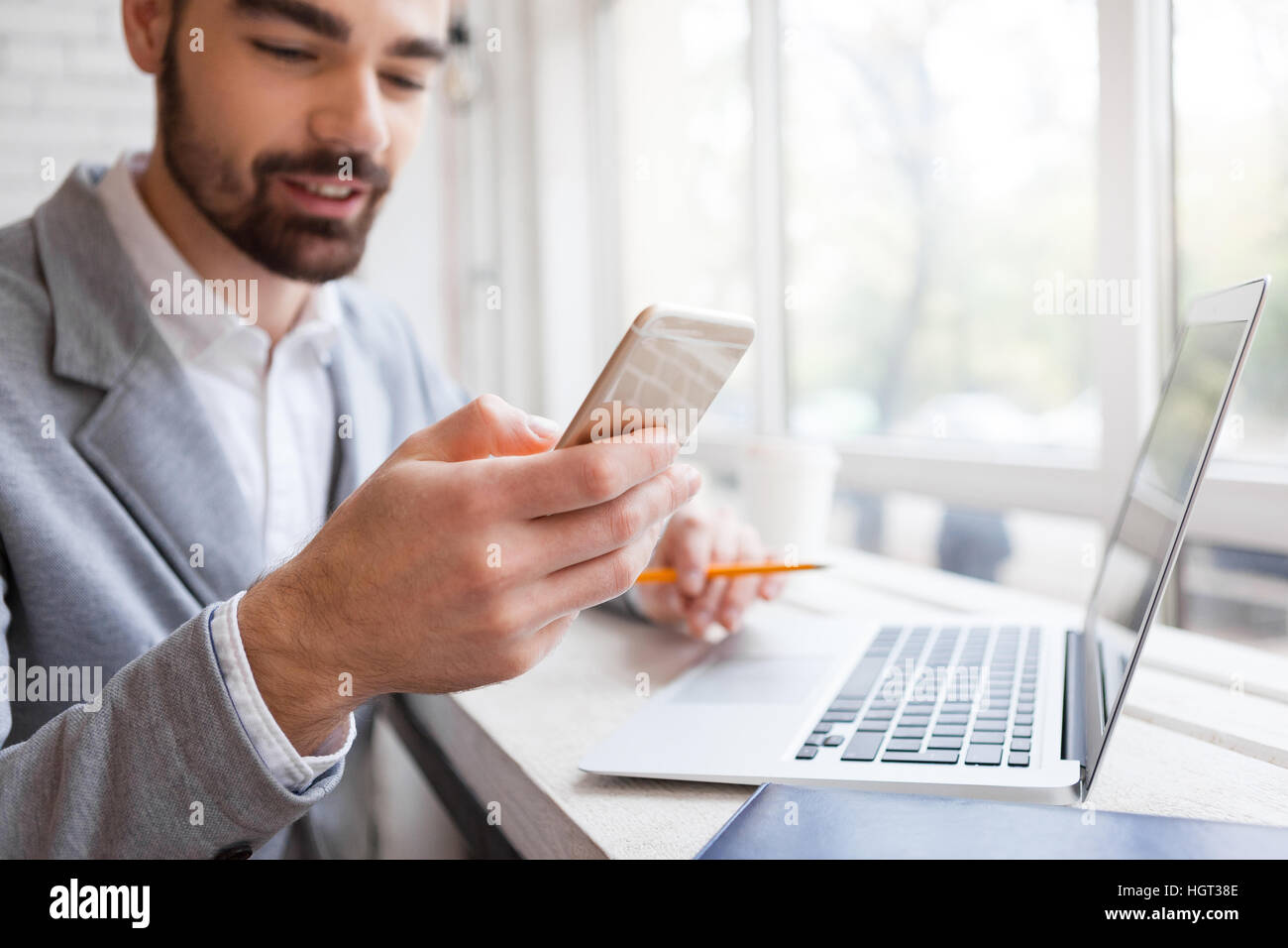 Modern employee texting in smartphone Stock Photo - Alamy