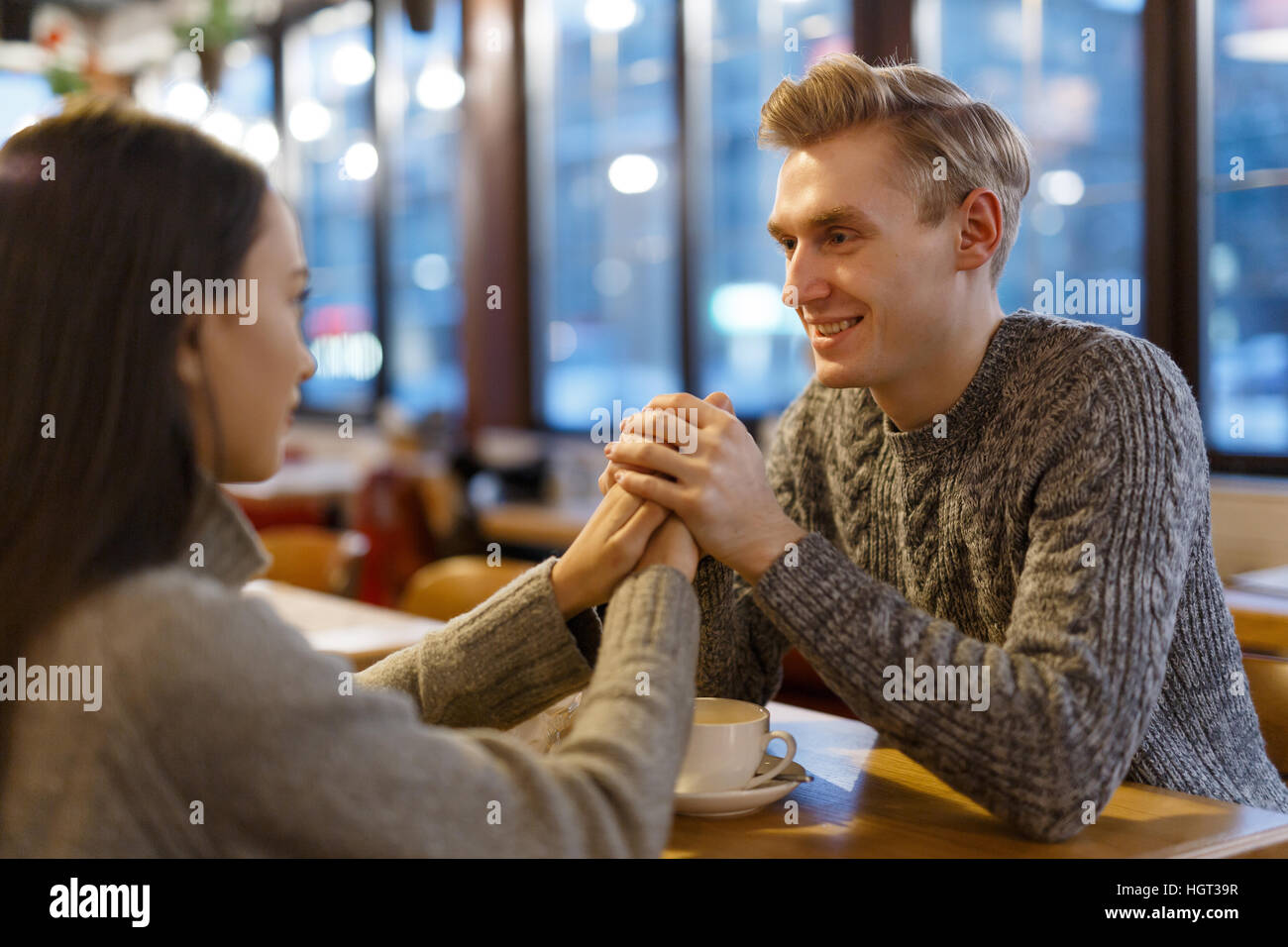 Affectionate couple spending holiday evening in cafe Stock Photo - Alamy