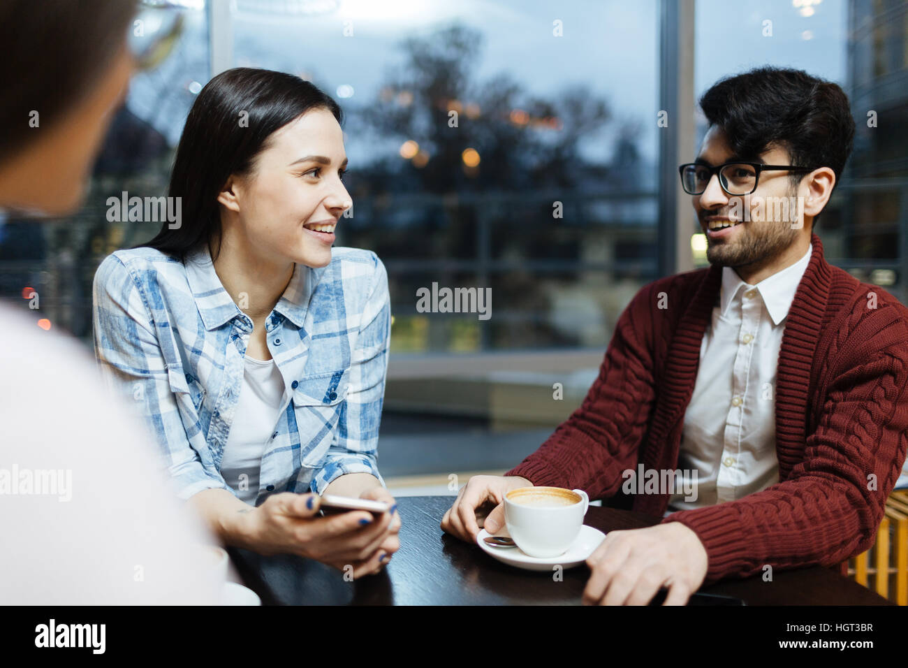 Creative young people having talk in cafe at leisure Stock Photo - Alamy