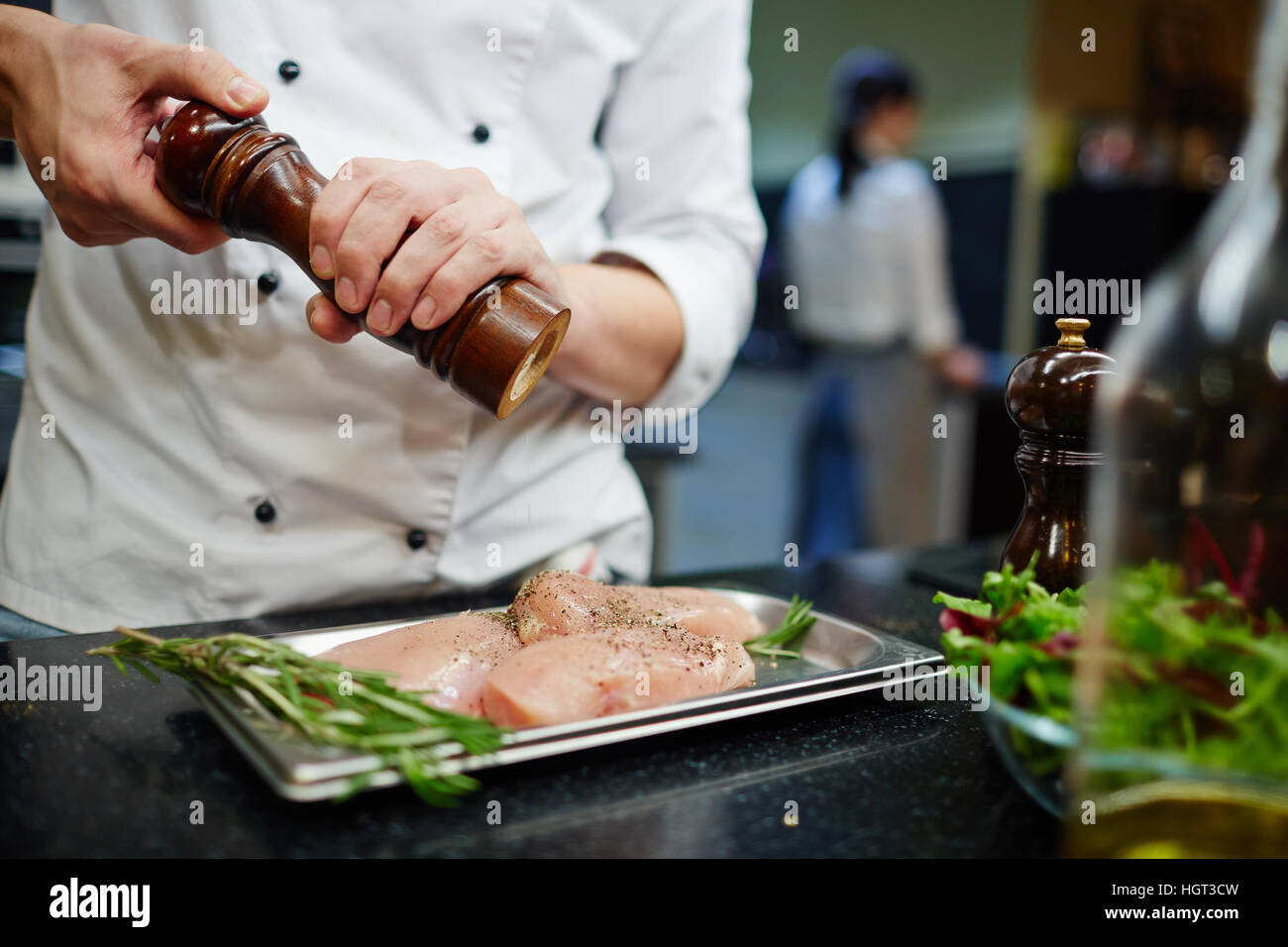 Chief seasoning raw chicken sirloin with aromatic spices Stock Photo ...