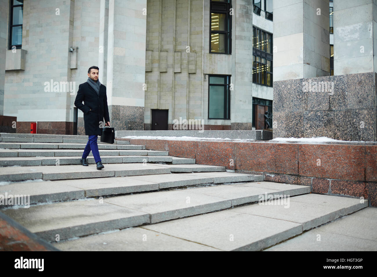 White collar worker with briefcase walking downstairs Stock Photo - Alamy