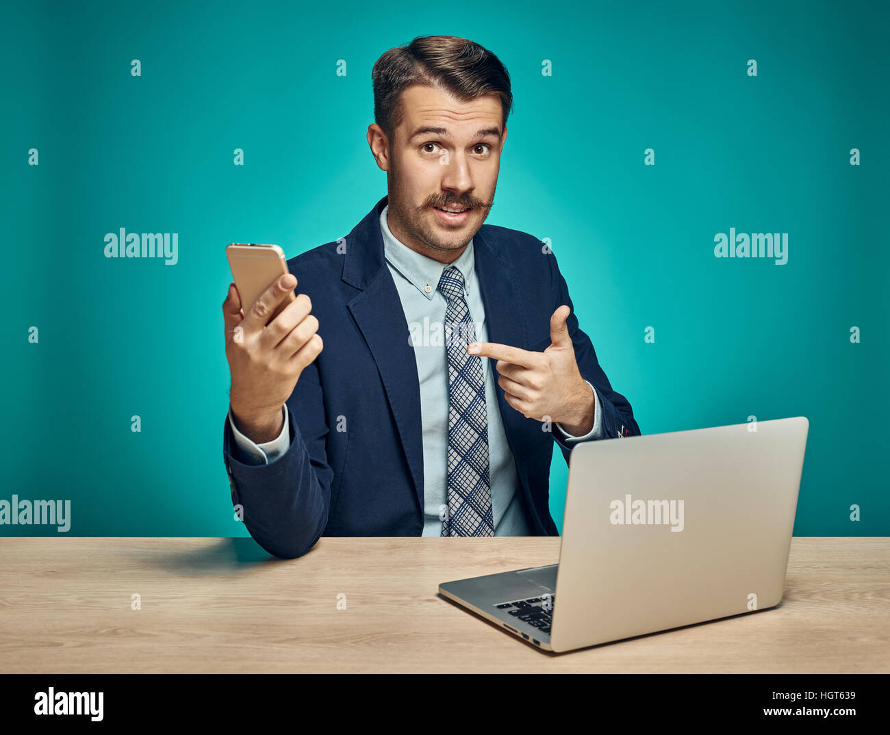 Sad Young Man Working On Laptop At Desk Stock Photo - Alamy