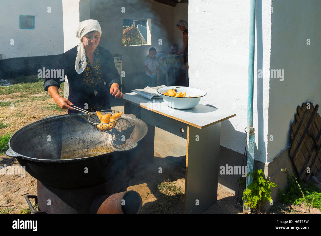 Kazakh Woman preparing the traditional local tandyr bread, Shymkent ...