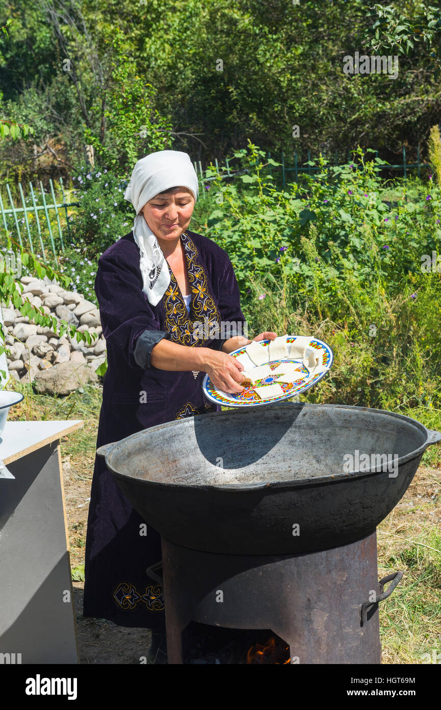 Kazakh Woman preparing the traditional local tandyr bread, Shymkent ...