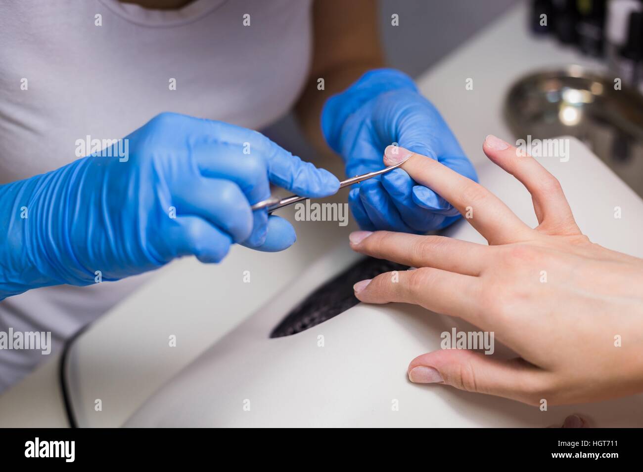 Manicurist clear cuticle with professional scissors for manicure Stock ...