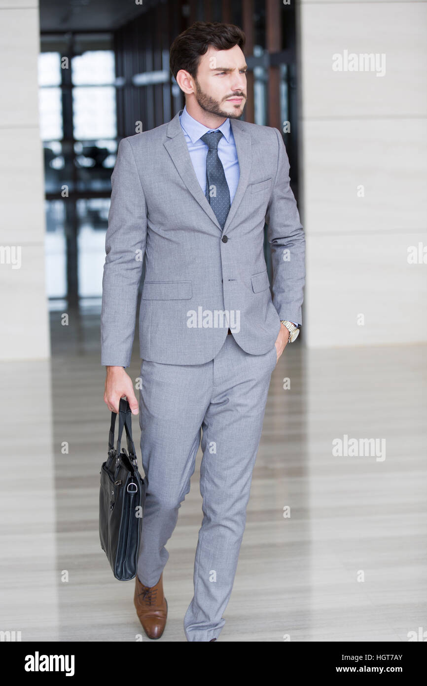 Confident businessman walking with briefcase Stock Photo - Alamy Confident businessman walking with briefcase Stock Photo - Alamy