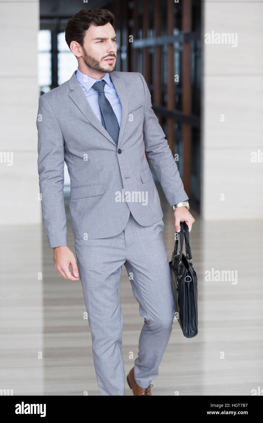 Confident businessman walking with briefcase Stock Photo - Alamy Confident businessman walking with briefcase Stock Photo - Alamy