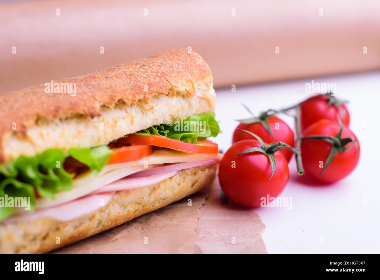Fresh crusty baguette with ham, cheese, tomato and green salad Stock ...