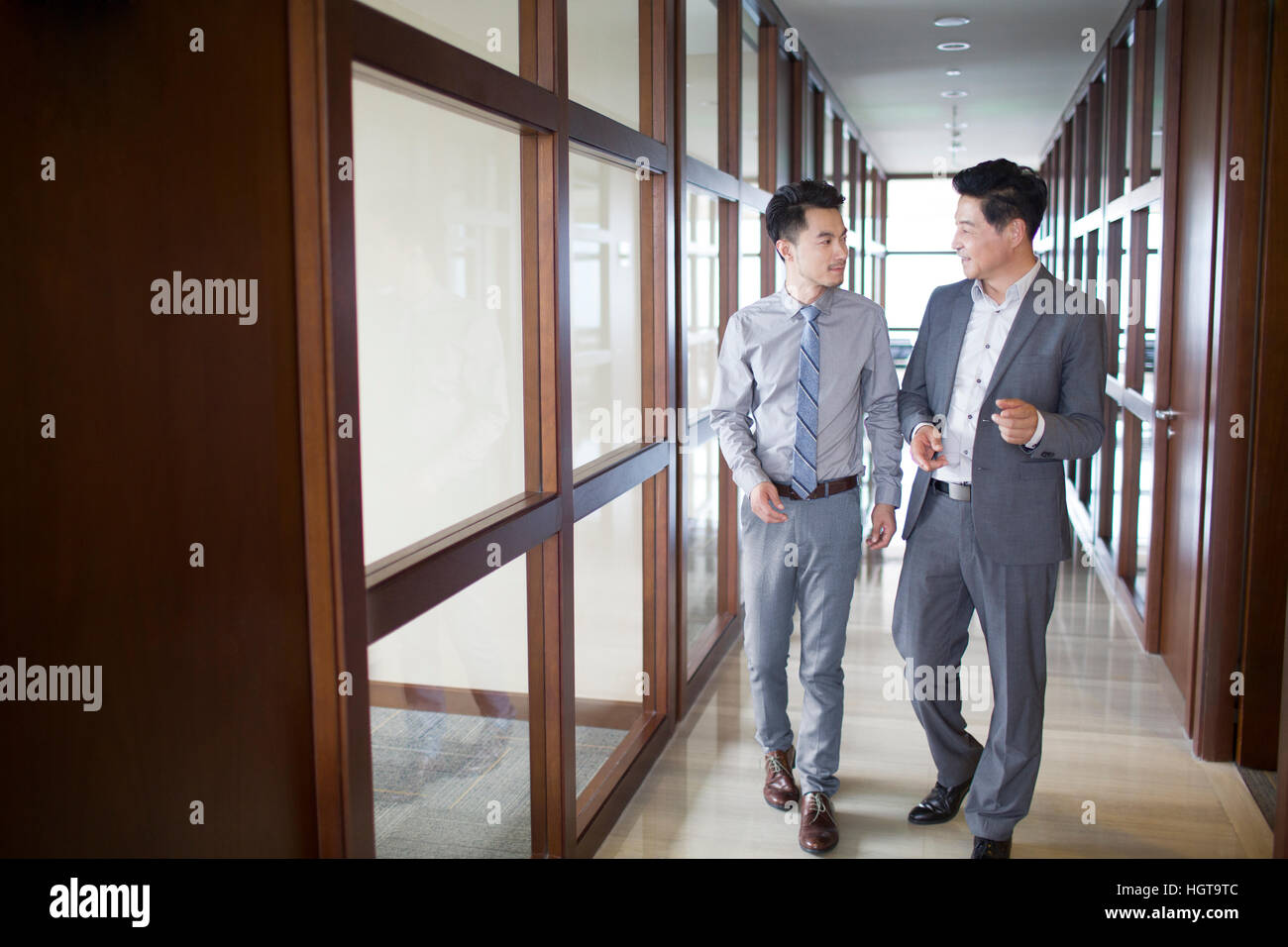Businessmen talking in office Stock Photo - Alamy