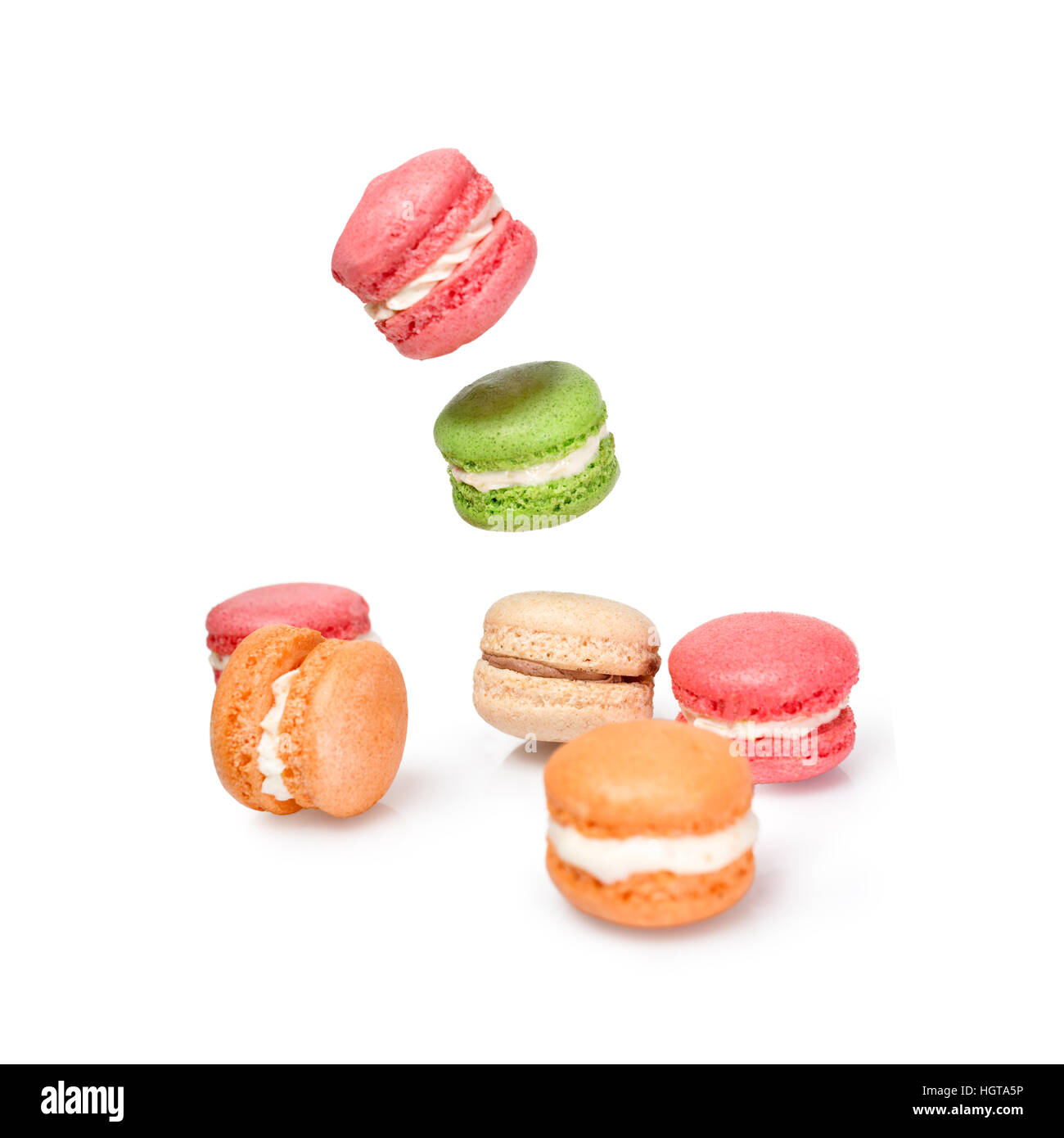 Different types of macaroons in motion falling or flying on white ...