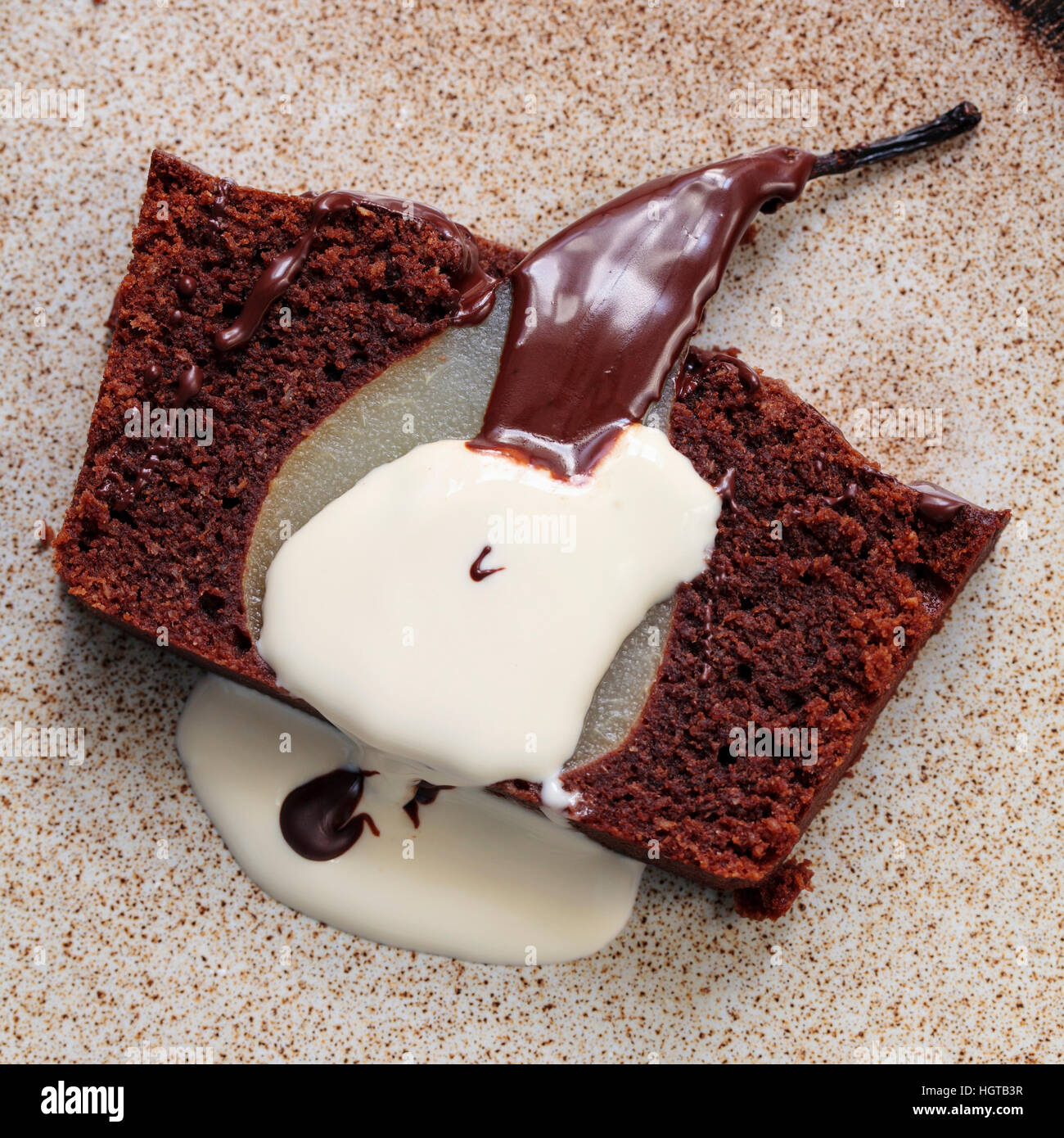 Chocolate sponge cake with poached pear Stock Photo - Alamy