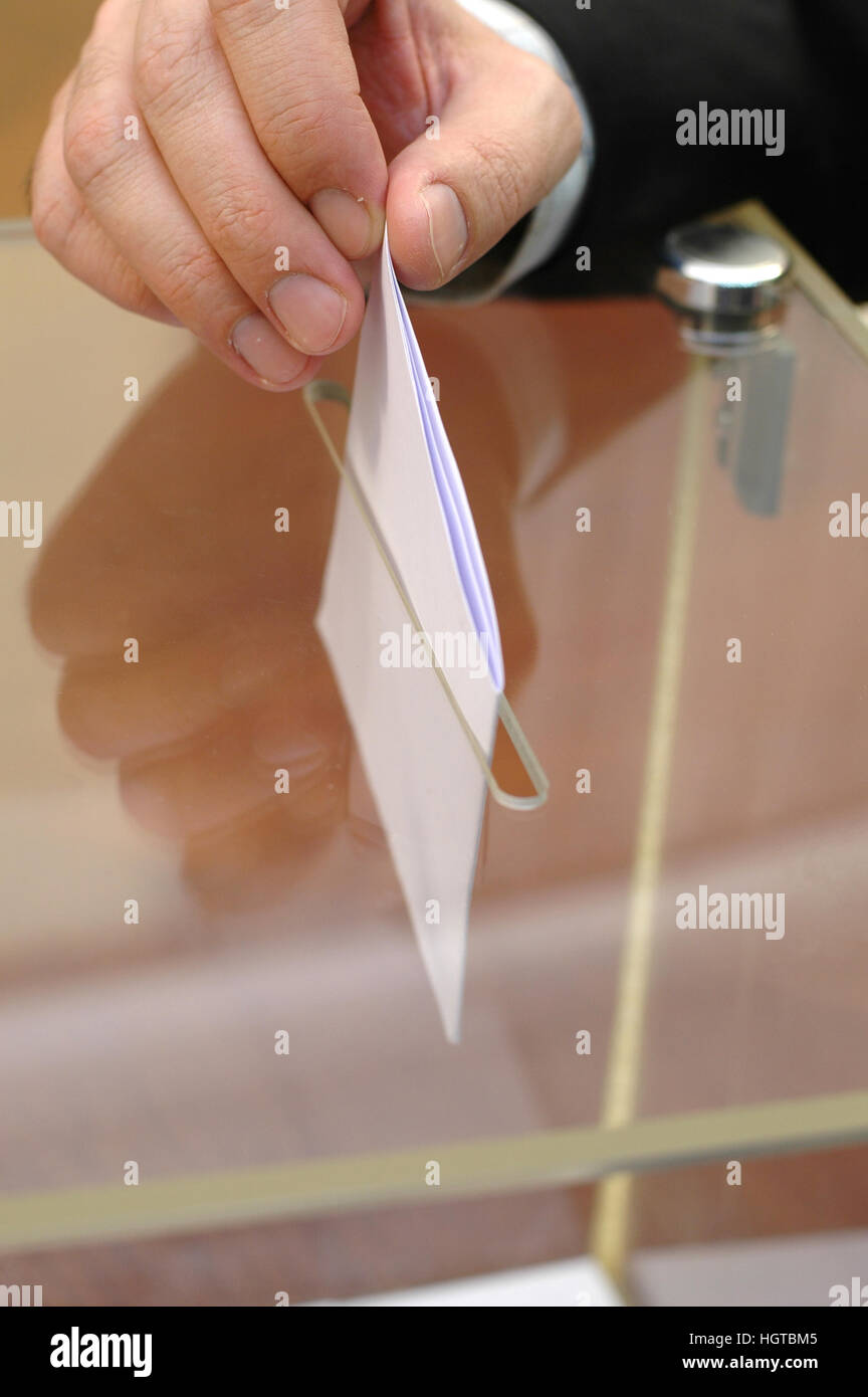 Image of a ballot box and hand putting a blank ballot inside,elections ...