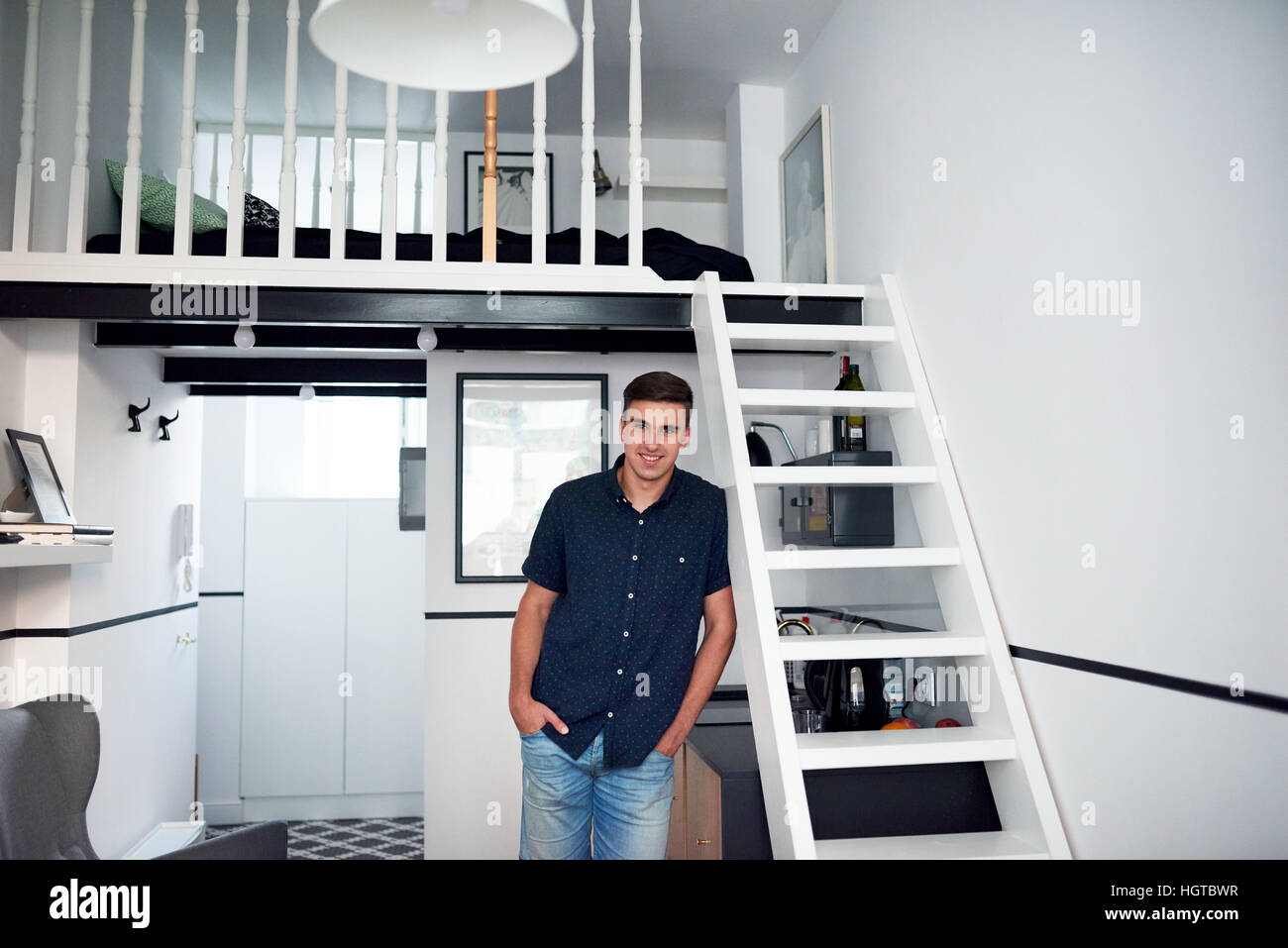 Handsome young man relaxing in his loft apartment Stock Photo - Alamy