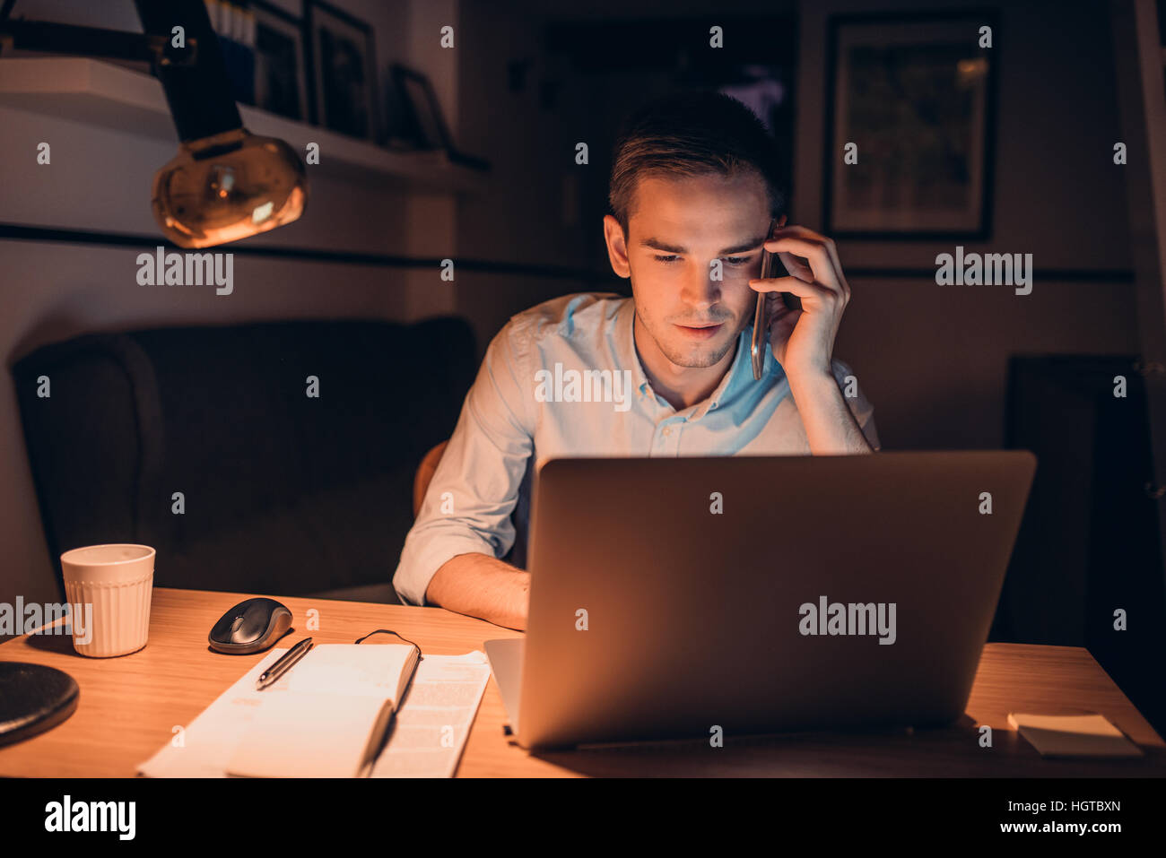 Young businessman hard at work late in the evening Stock Photo - Alamy