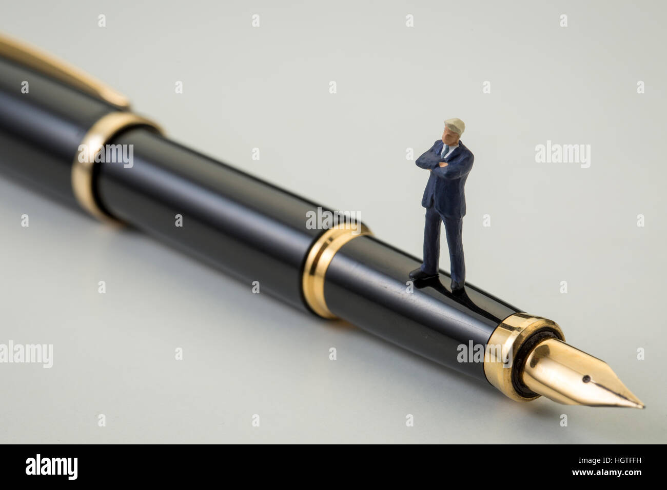 Figure of businessman on a pen Stock Photo - Alamy