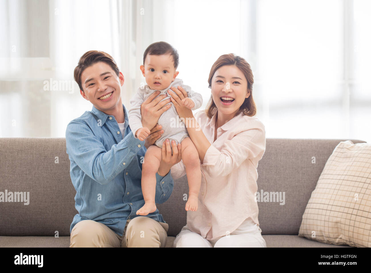 Harmonious family with baby Stock Photo - Alamy