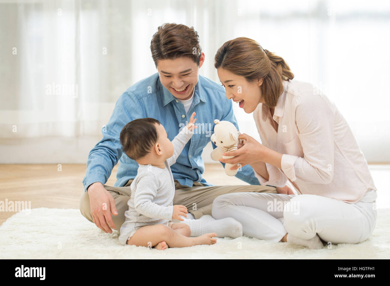 Harmonious family with baby Stock Photo - Alamy