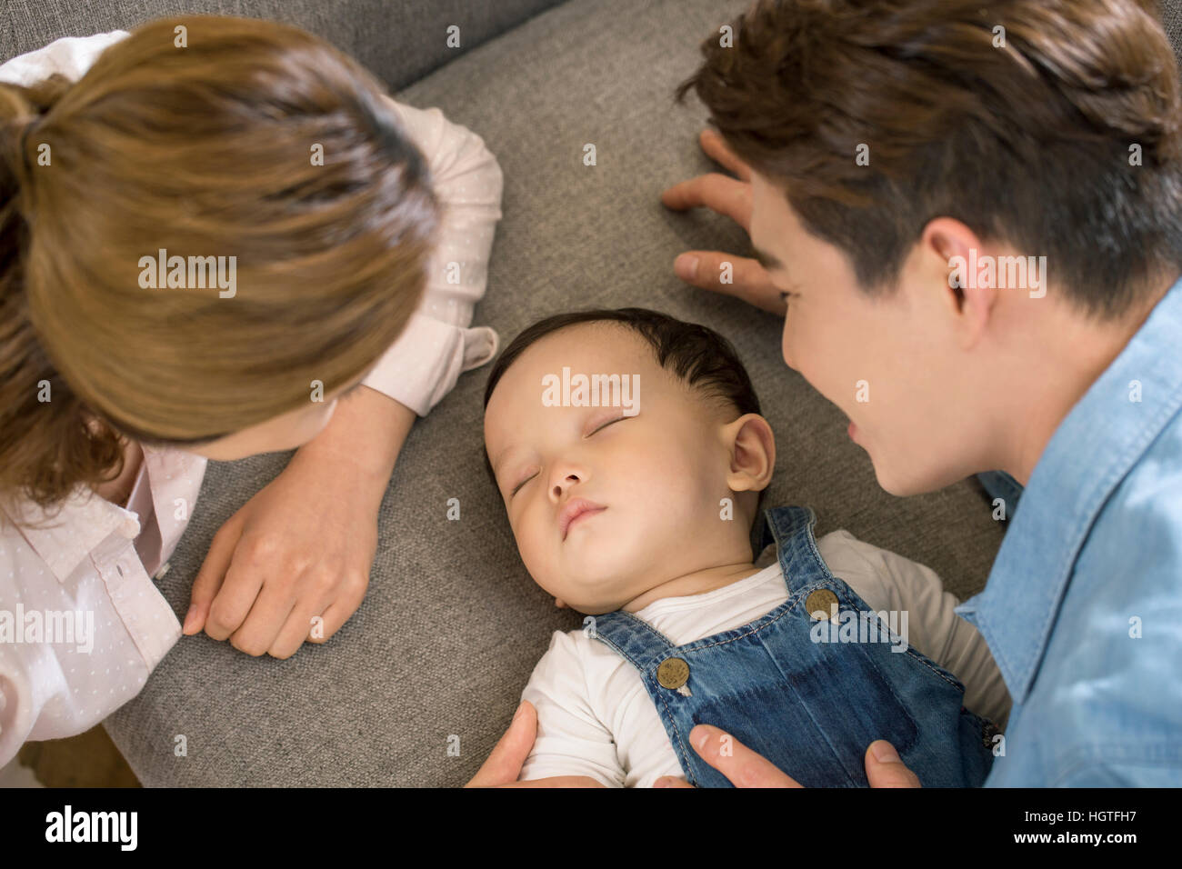 Loving parents taking care of baby Stock Photo - Alamy