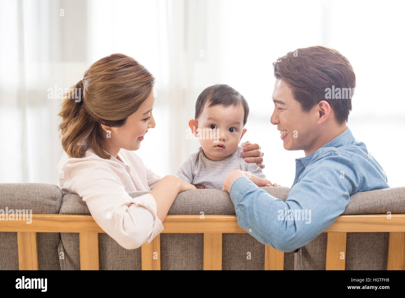 Loving parents taking care of baby Stock Photo - Alamy