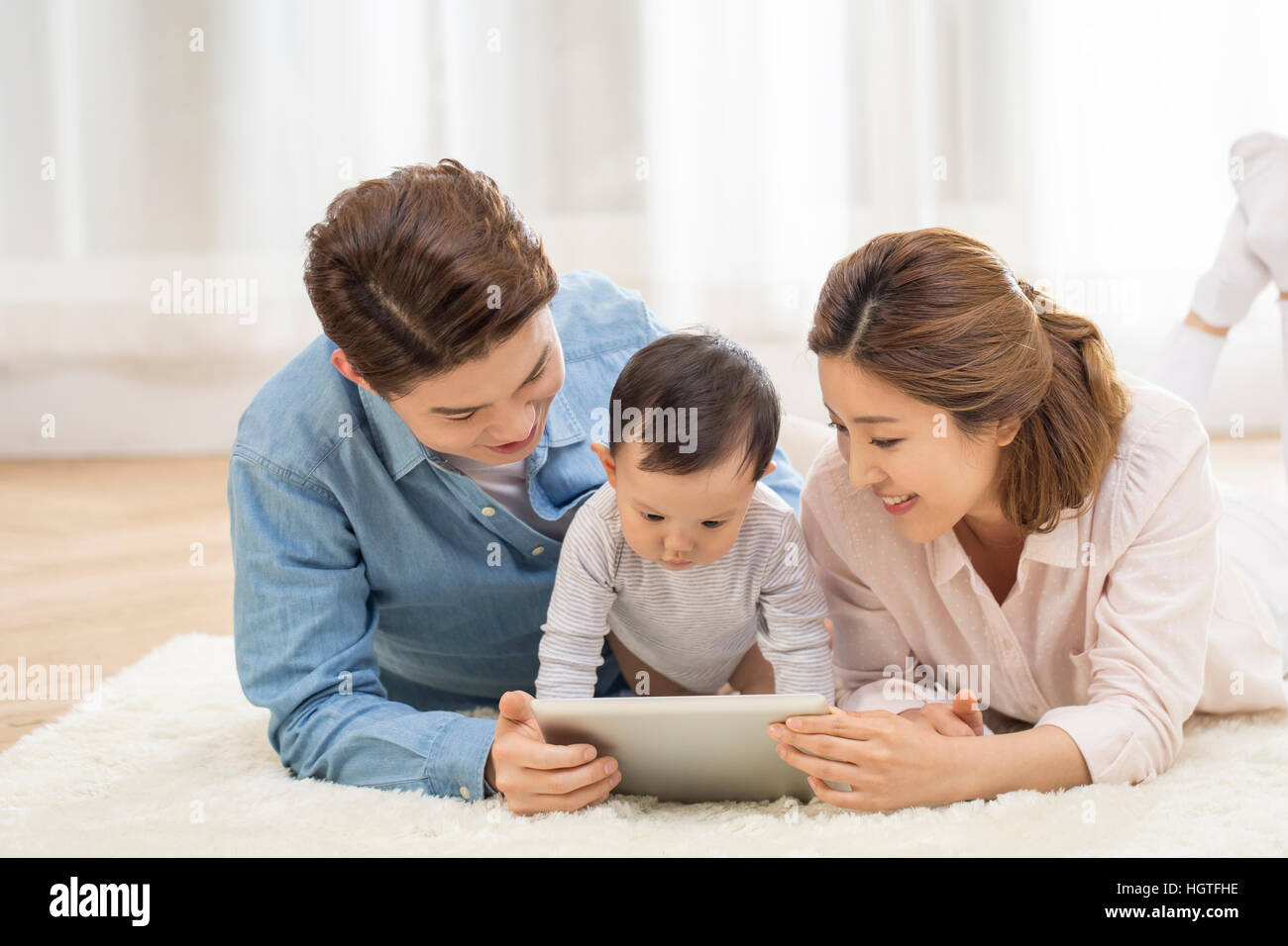 Harmonious family with baby Stock Photo - Alamy