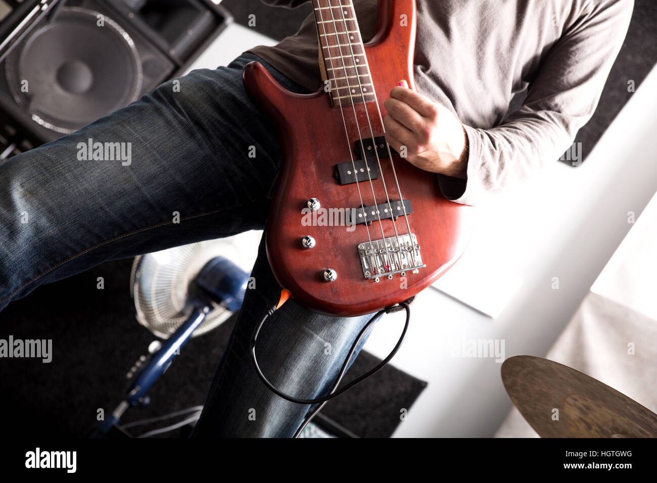 A Rock singer playing bass in the rehearsal Studio Stock Photo - Alamy