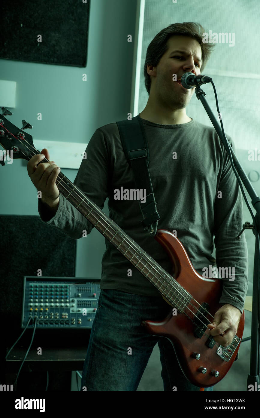 Black and white Portrait of a Rock singer playing bass in the rehearsal ...