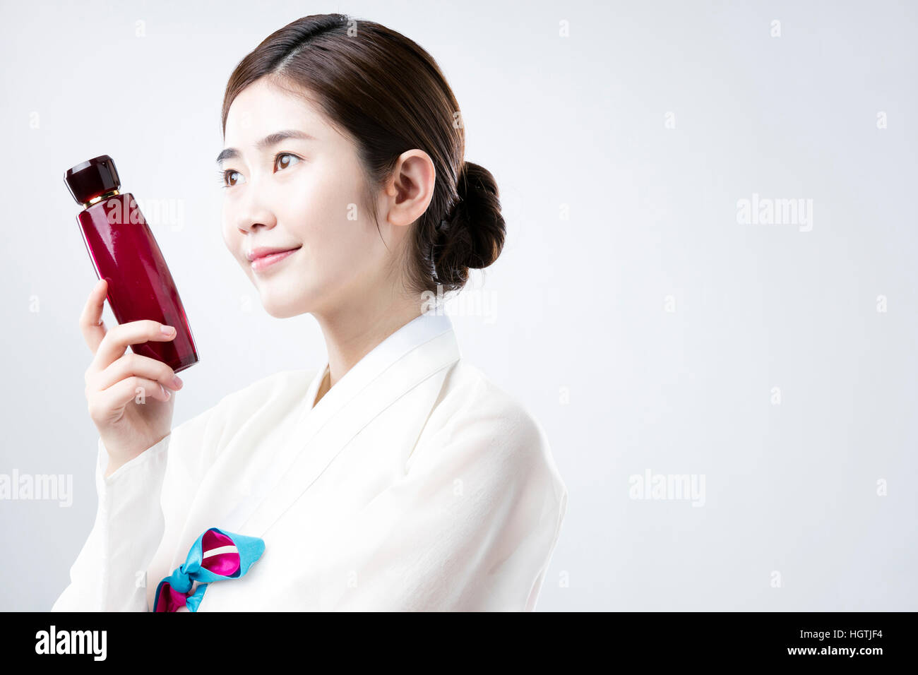 Side view portrait of young woman in traditional Korean clothes posing ...