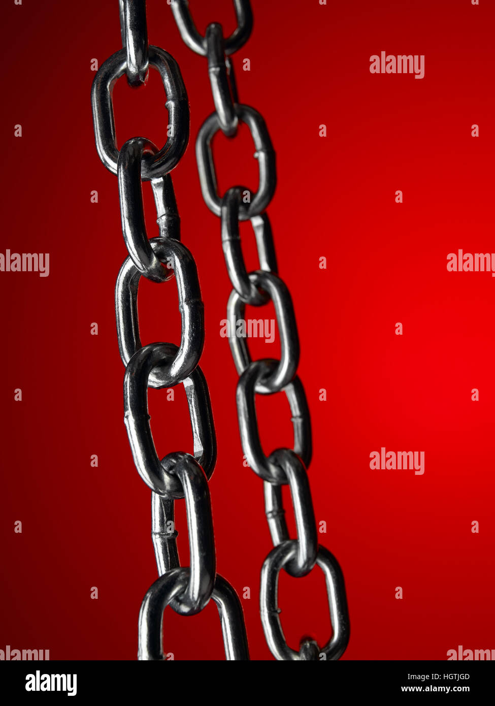 Chain with a red background Stock Photo - Alamy