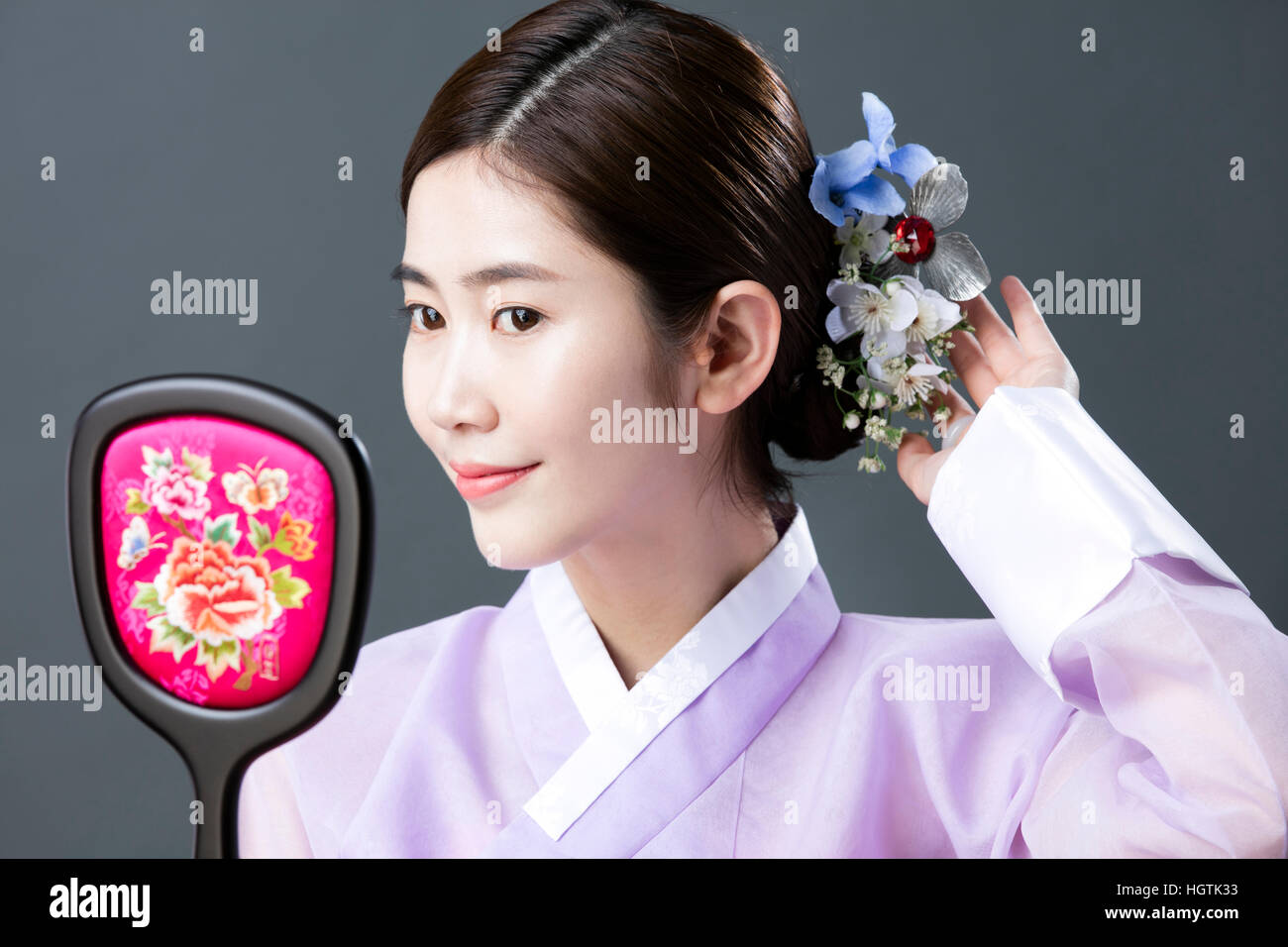 Side view portrait of young woman in traditional Korean clothes looking ...