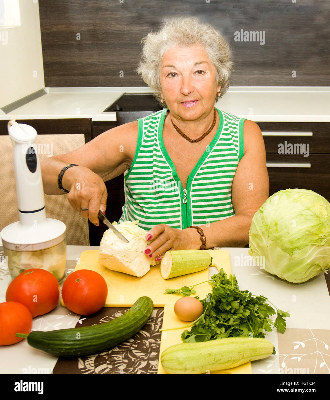Old woman in kitchen cooking Stock Photo - Alamy