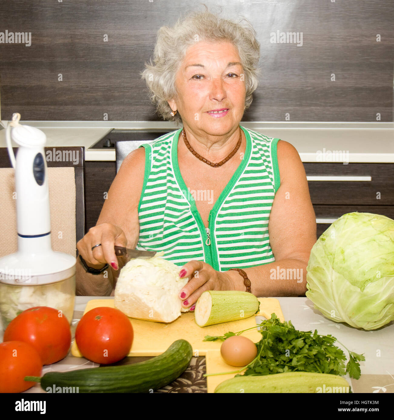 Elderly woman cooking Stock Photo - Alamy