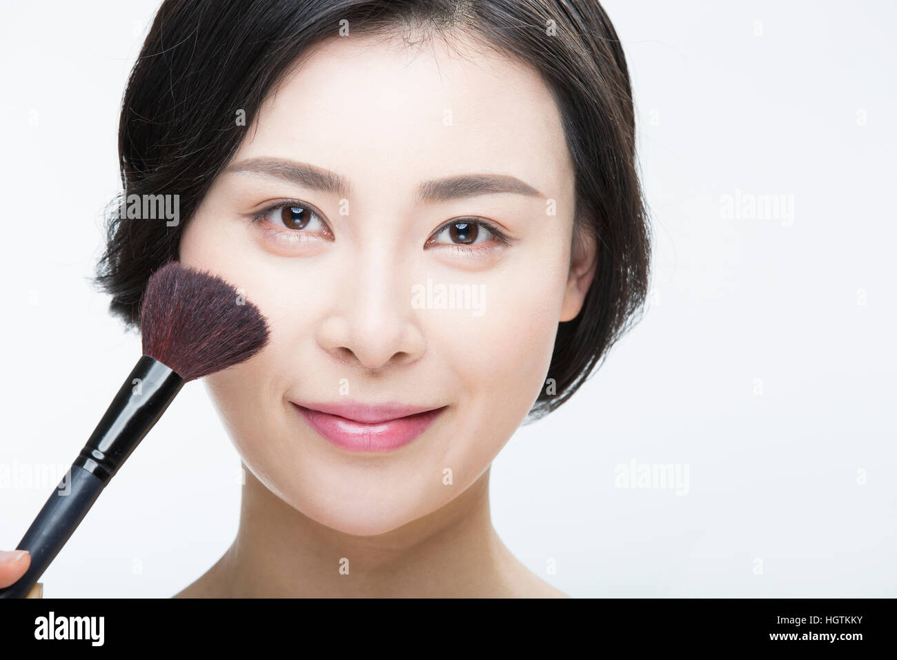 Woman using blusher brush hi-res stock photography and images - Alamy
